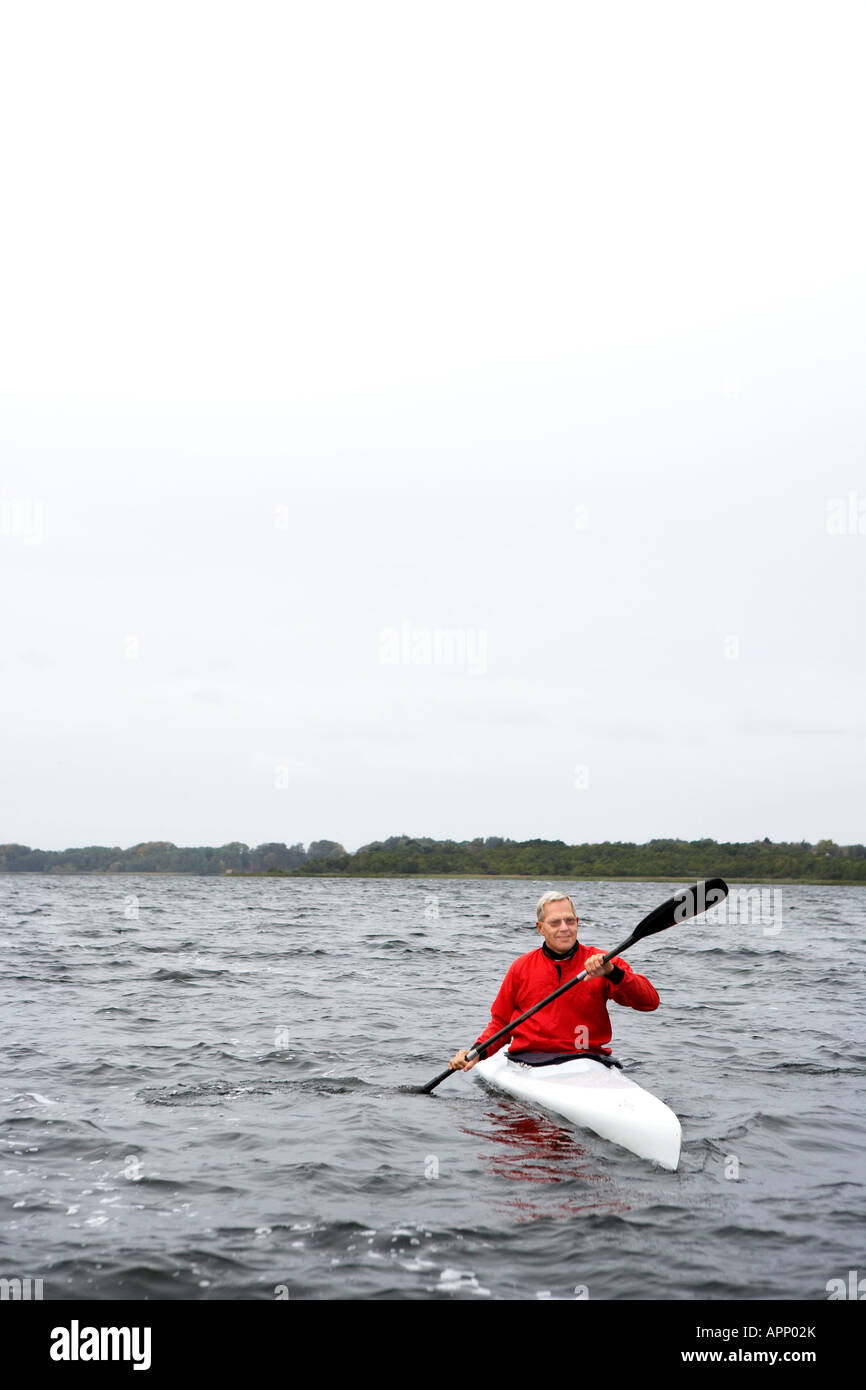Senior man kayaking in lake Stock Photo - Alamy