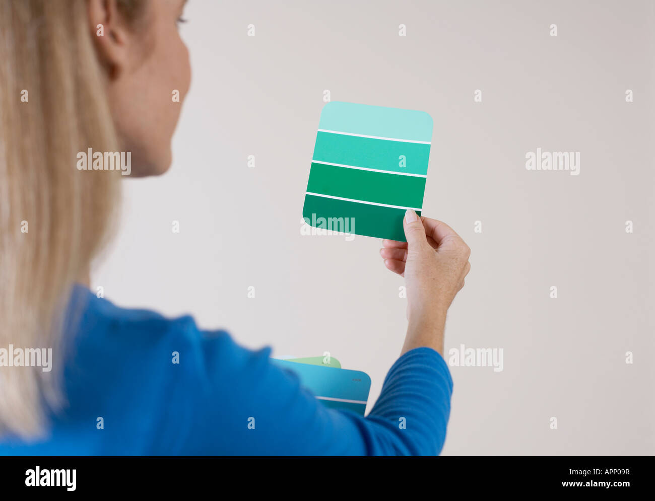 Mature woman looking at color swatches Stock Photo - Alamy
