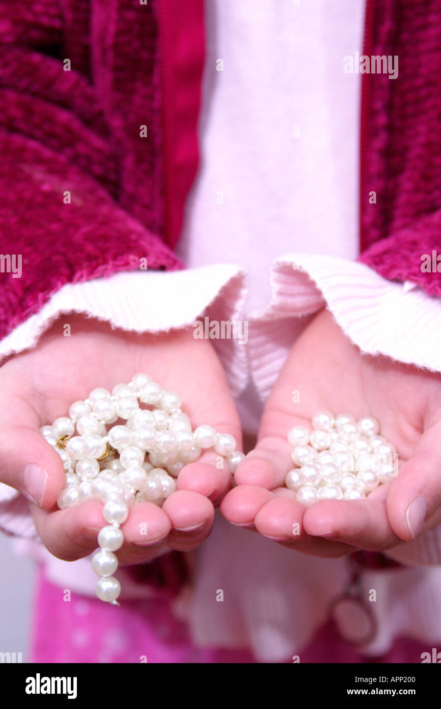 broken string of pearls in childs hands Stock Photo - Alamy