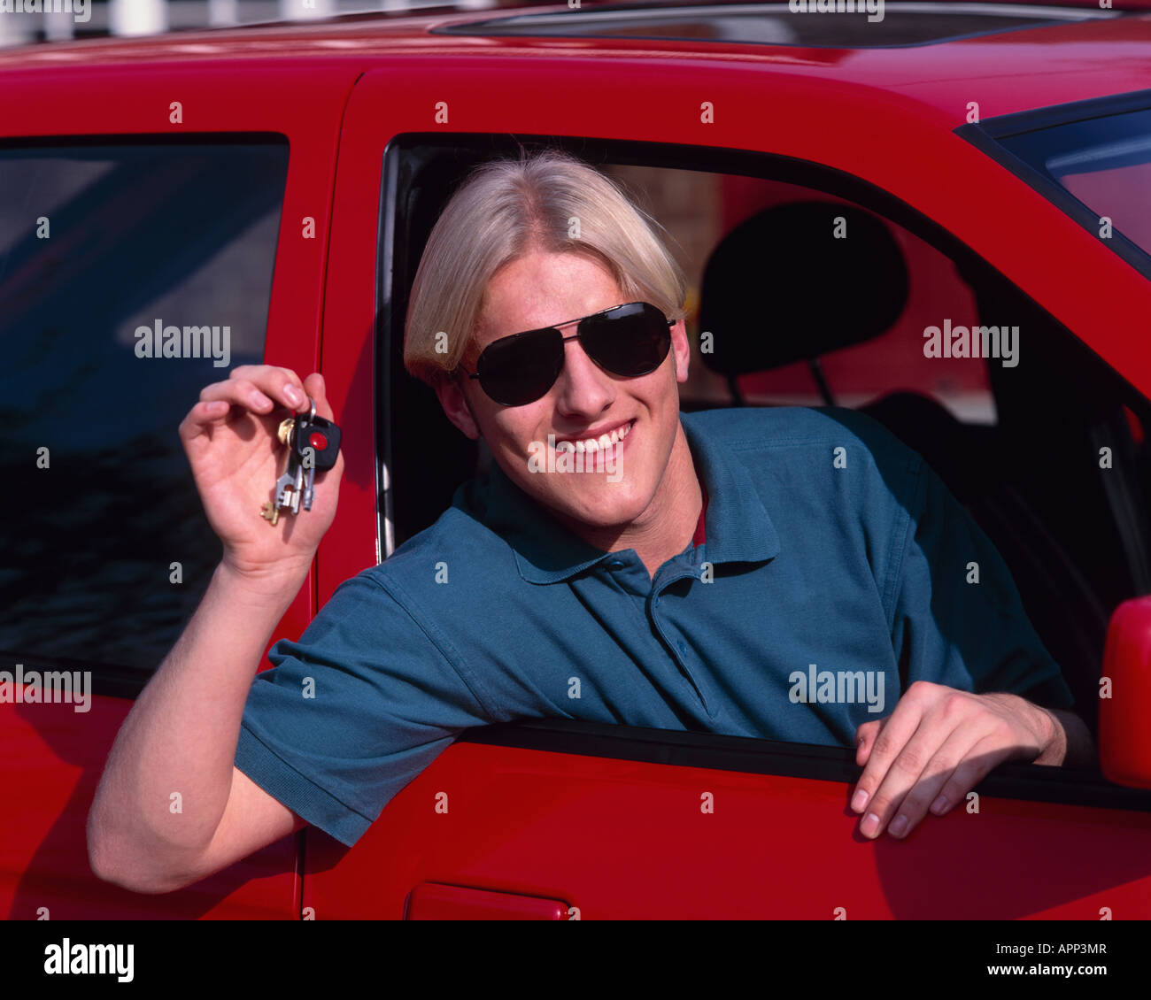 Young driver man holding up keys Stock Photo - Alamy