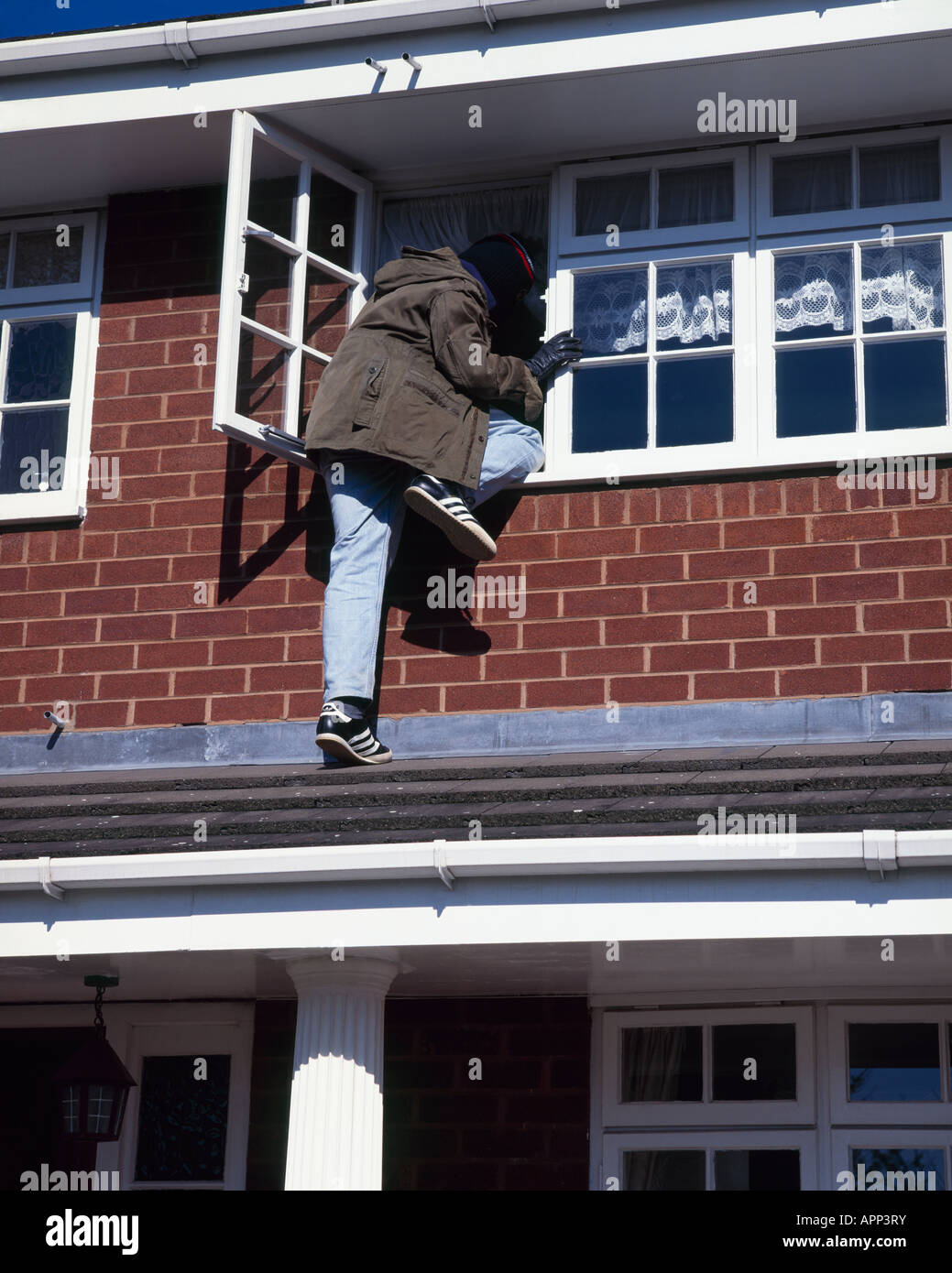 Burglar entering window Stock Photo - Alamy