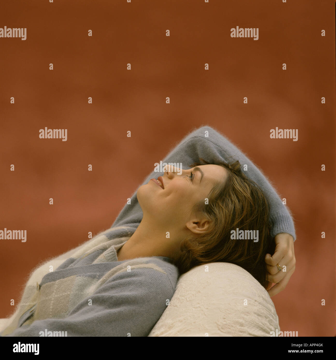 Young woman leaning back and relaxing in chair Stock Photo - Alamy