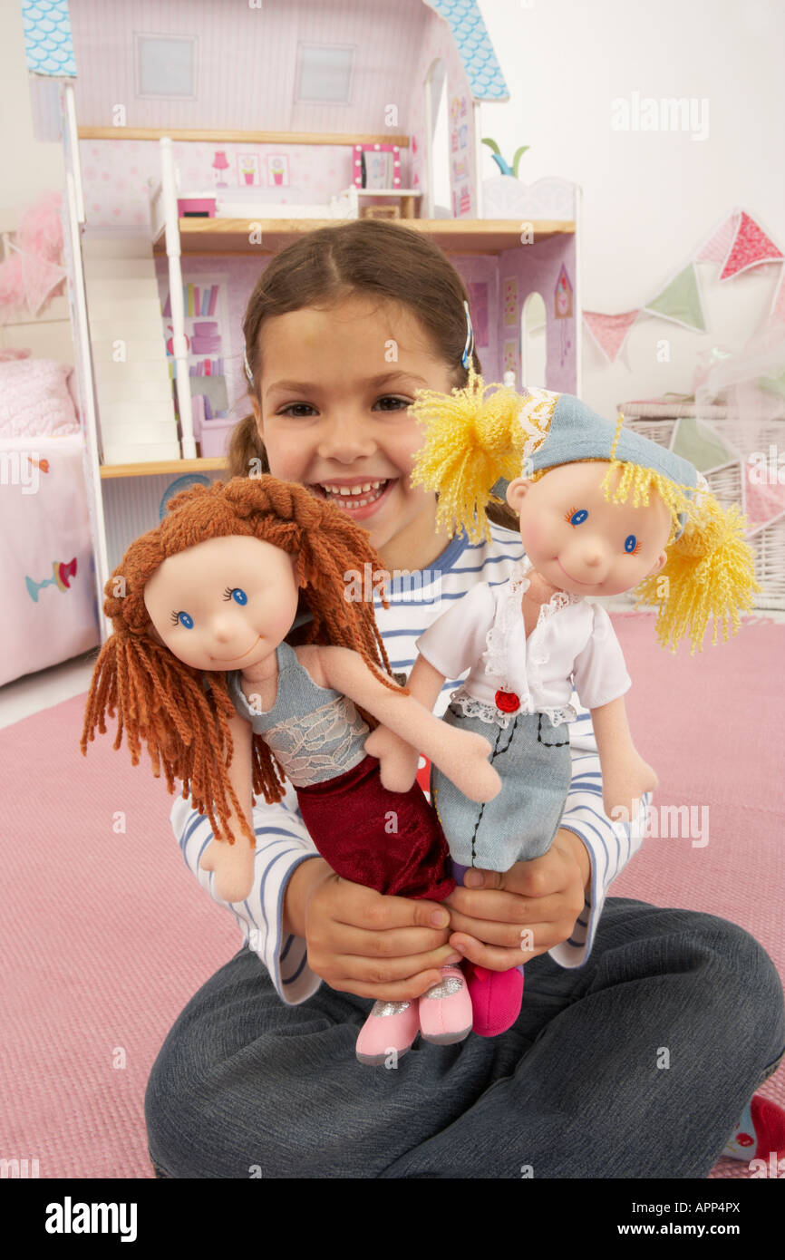 a girl plays in her bedroom with two dolls Stock Photo - Alamy