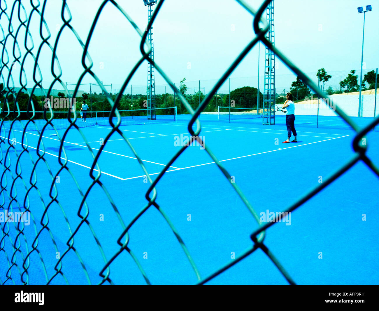 People playing at tennis court Stock Photo - Alamy