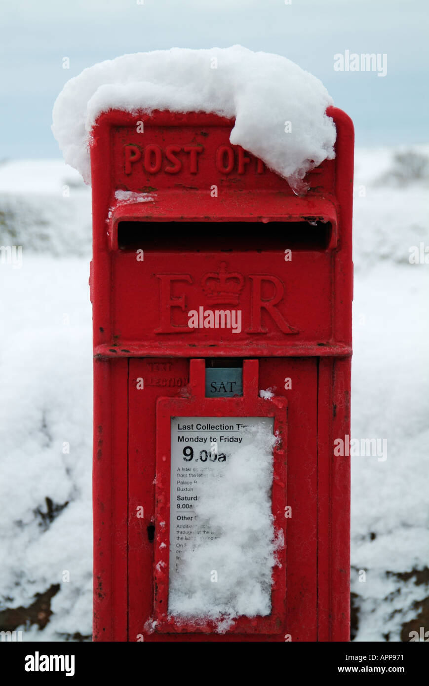 Rural old red post box covered in snow Derbyshire Peak district England ...