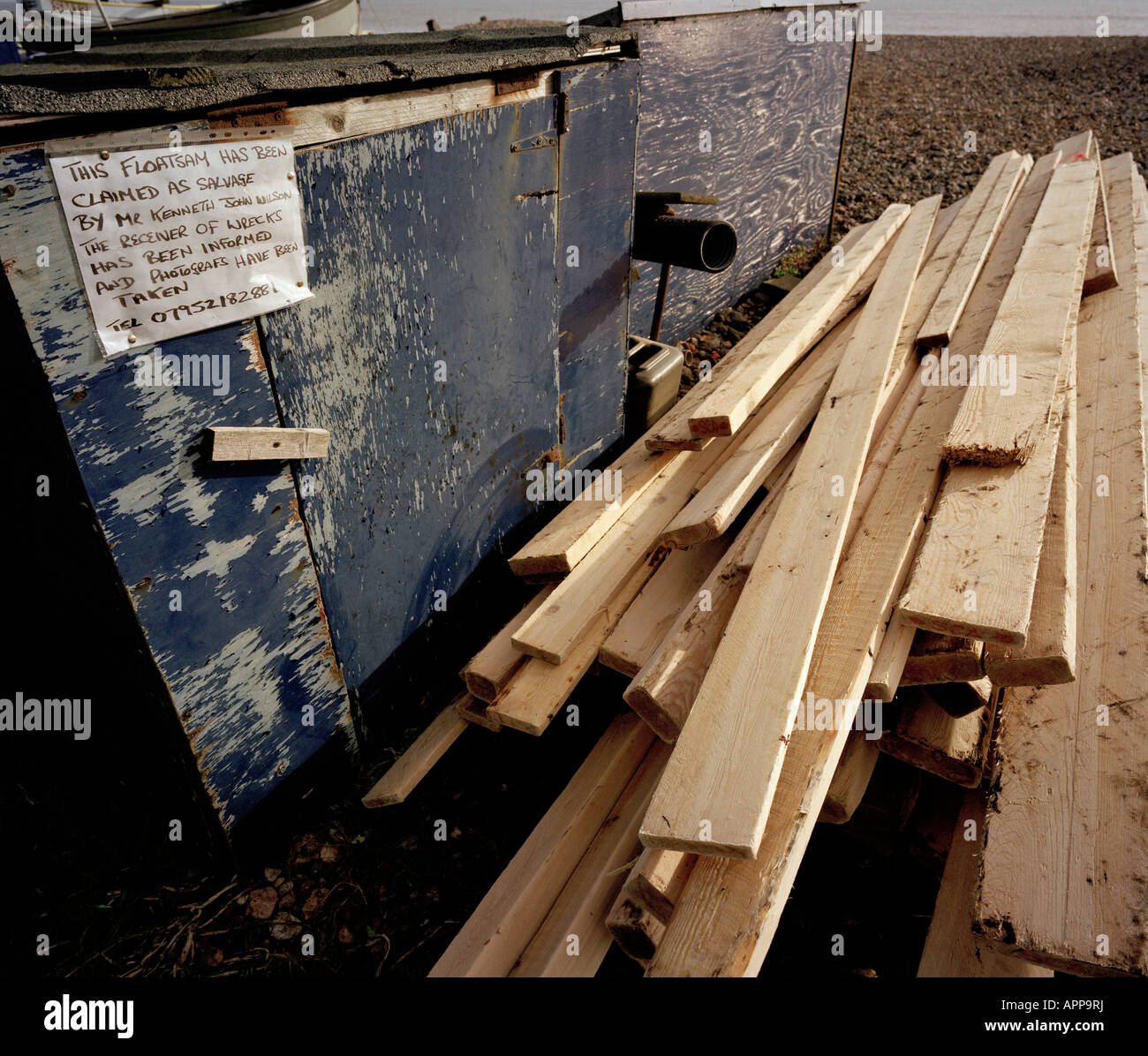 Stack of shipwreck timber with claim notice, Worthing, West Sussex ...