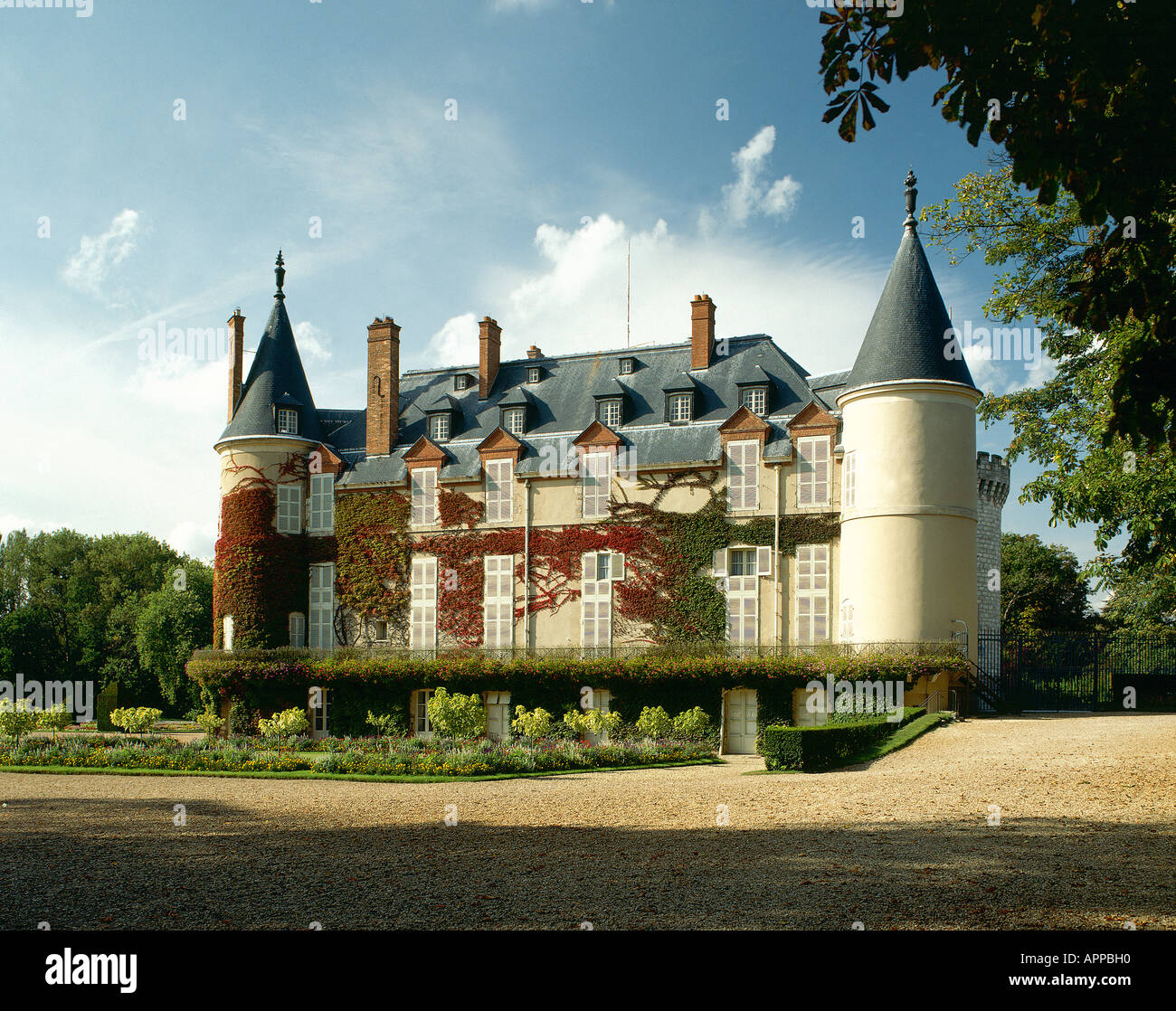 The ivy covered red brick 14th century Chateau de Rambouillet flanked ...