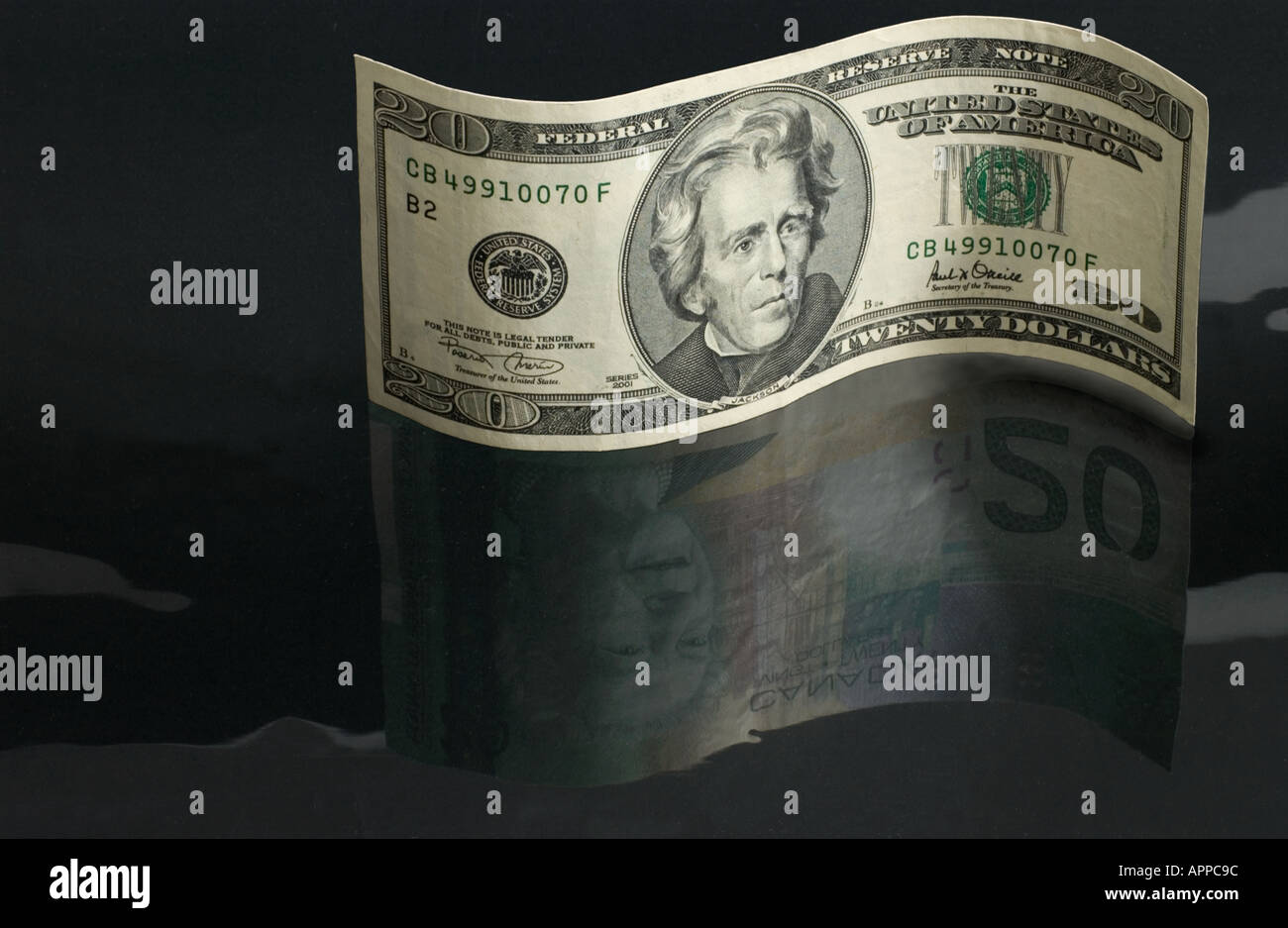 American 50 dollar bill with its reflection on black grey background ...