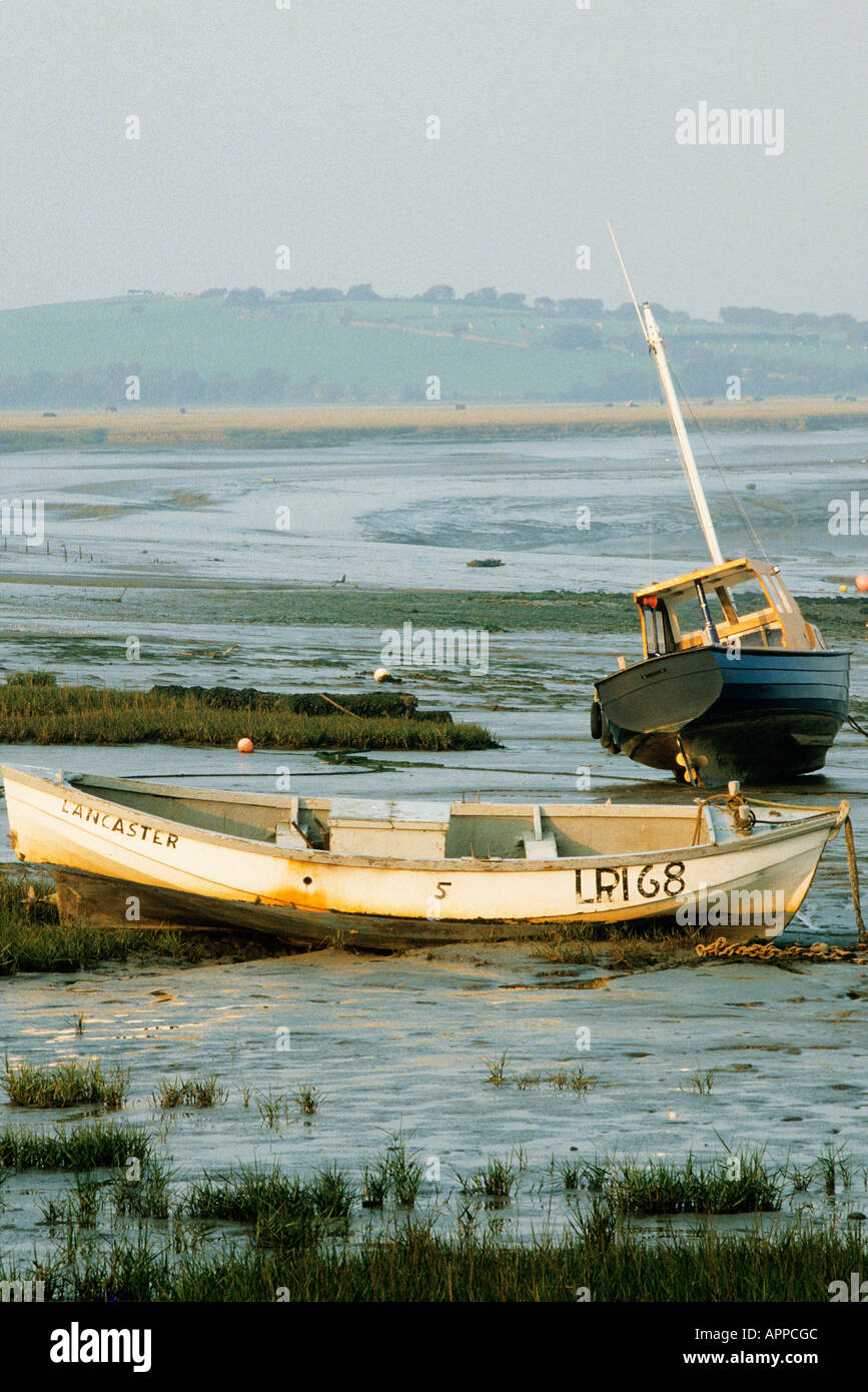 Two boats rest grounded on the sands of Sunderland Point Stock Photo ...