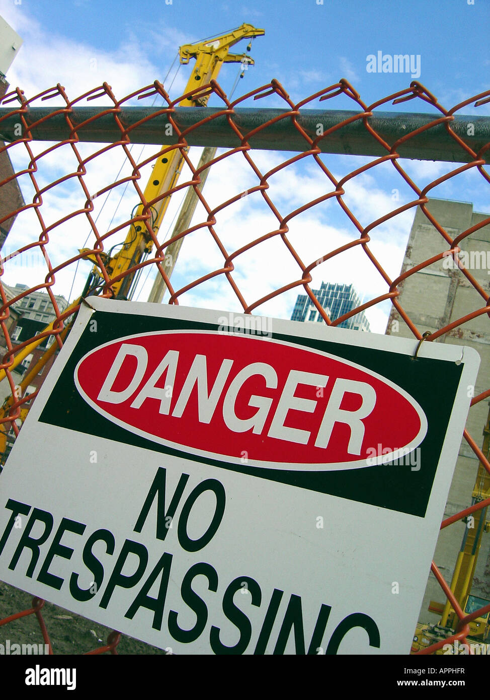 Industrial Scene With a Danger No Trespassing Sign on a Chain Link ...