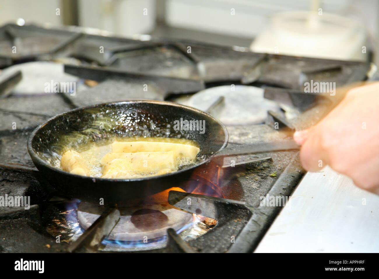 chef preparing food in a frying pan Stock Photo - Alamy