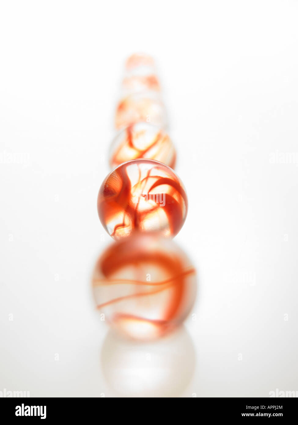 a line of red glass marbles Stock Photo - Alamy