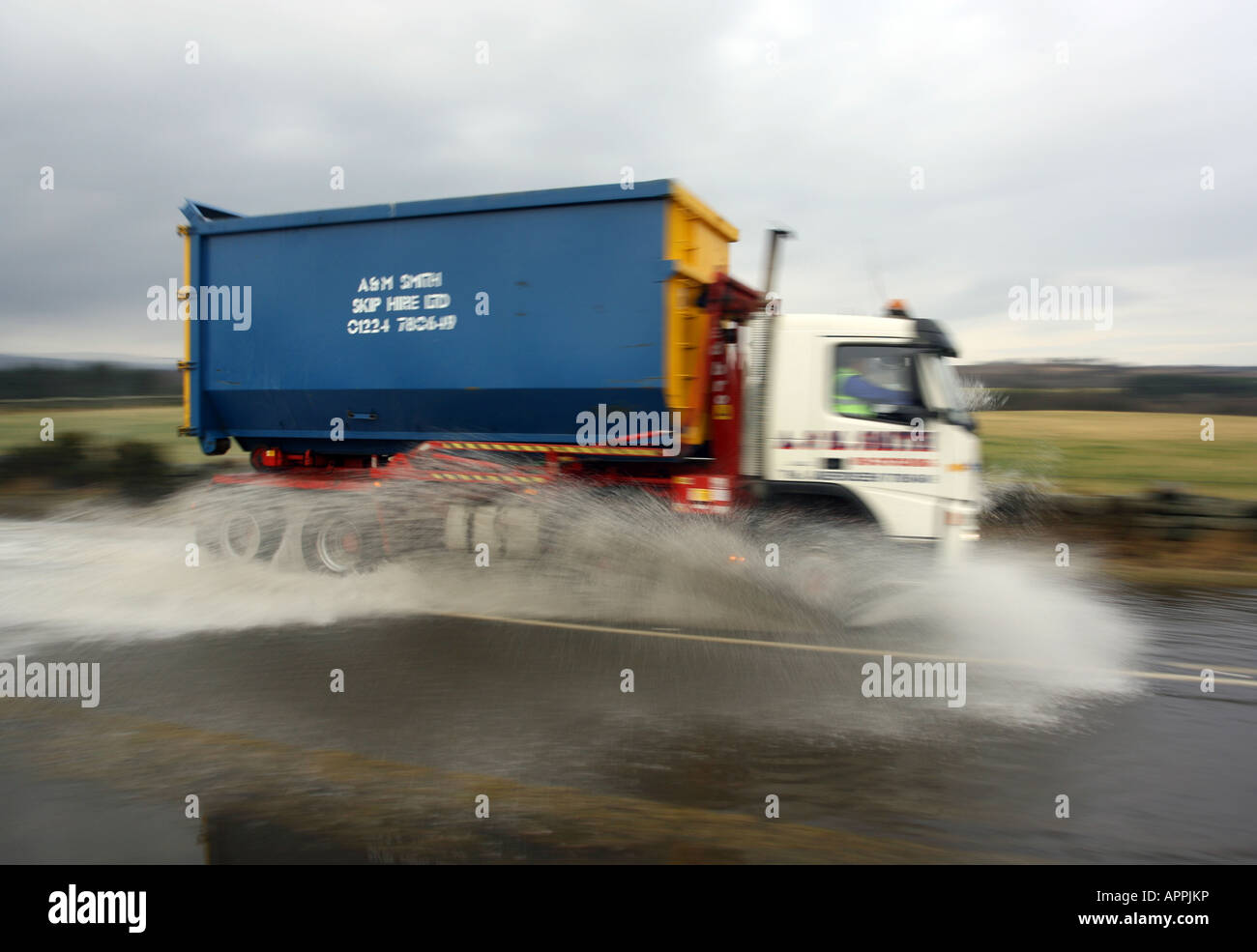 Spray flying from a lorry tyres during wet weather, heavy rain and ...