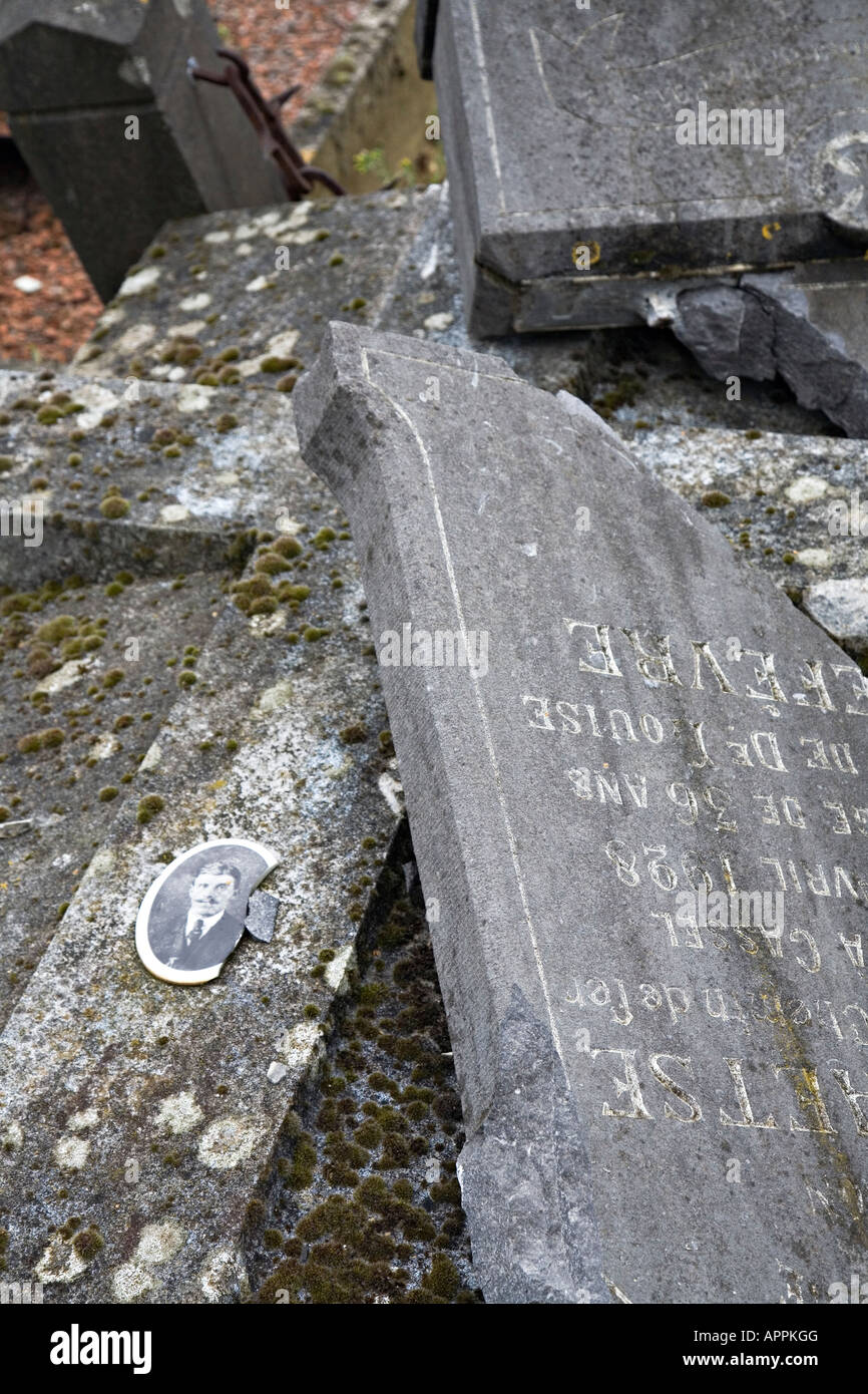 Broken gravestone and picture of deceased in the old part of cemetery ...