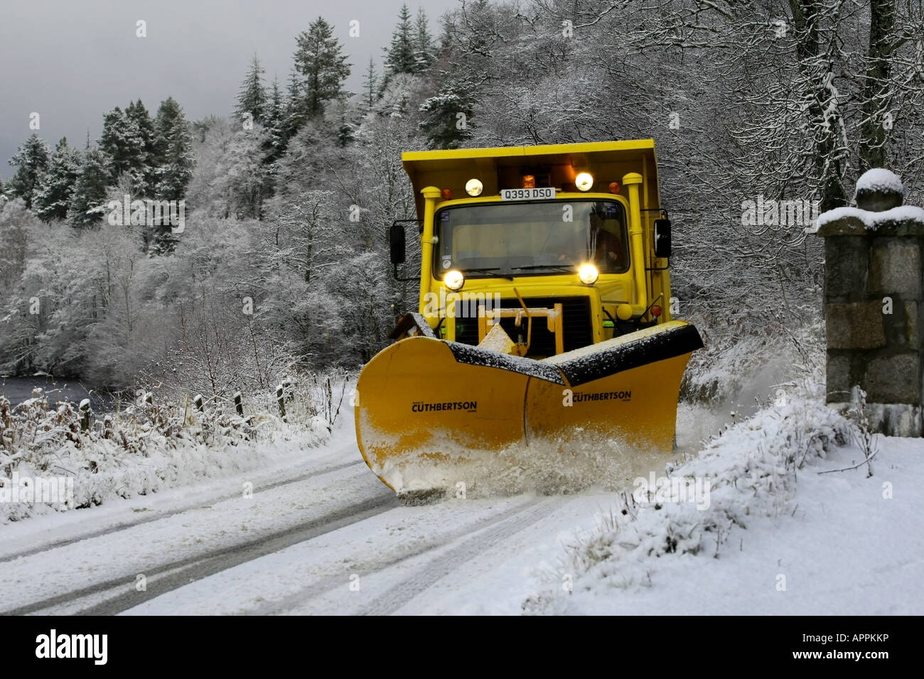 A yellow snowplough clearing roads of snow near Ballater in Royal ...