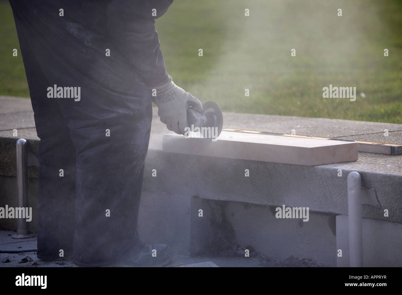 close up of man cutting stone with an angle grinder repairing ...