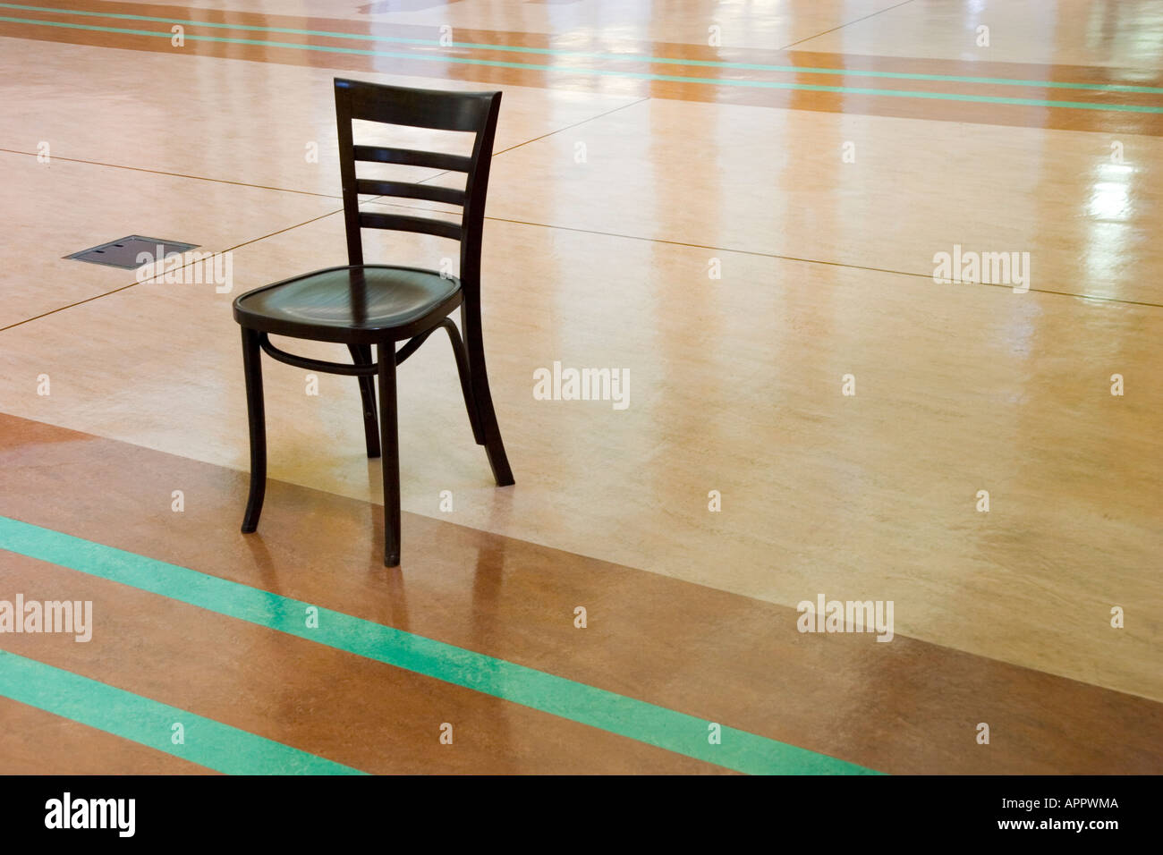 lone chair on striped wooden floor Stock Photo - Alamy