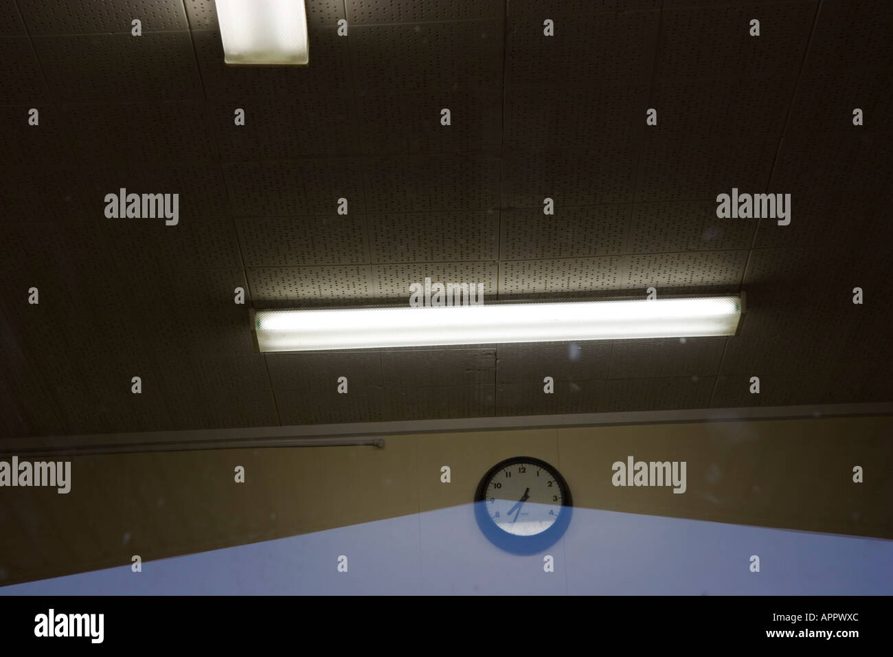 lights and clock through window Stock Photo - Alamy