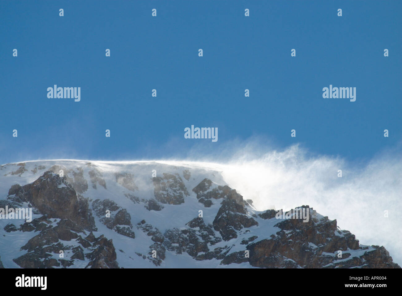 Wind blowing snow off mountain ridge Stock Photo - Alamy