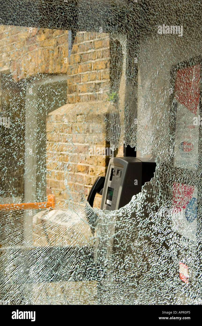 smashed up telephone box with broken glass Stock Photo - Alamy