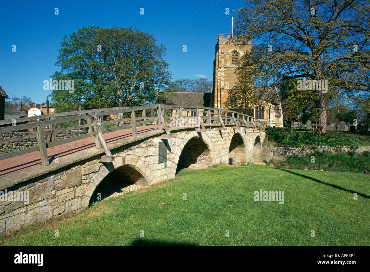 Medieval stone bridge over River Welland with late 13th century Church ...