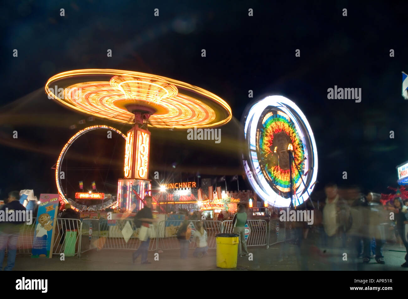 Fair grounds with ferris wheel and Yo yo ride Stock Photo - Alamy