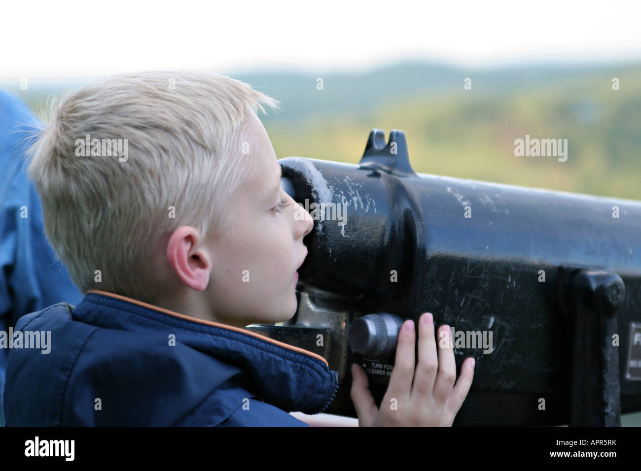 A child using a telescope during a school trip Stock Photo - Alamy