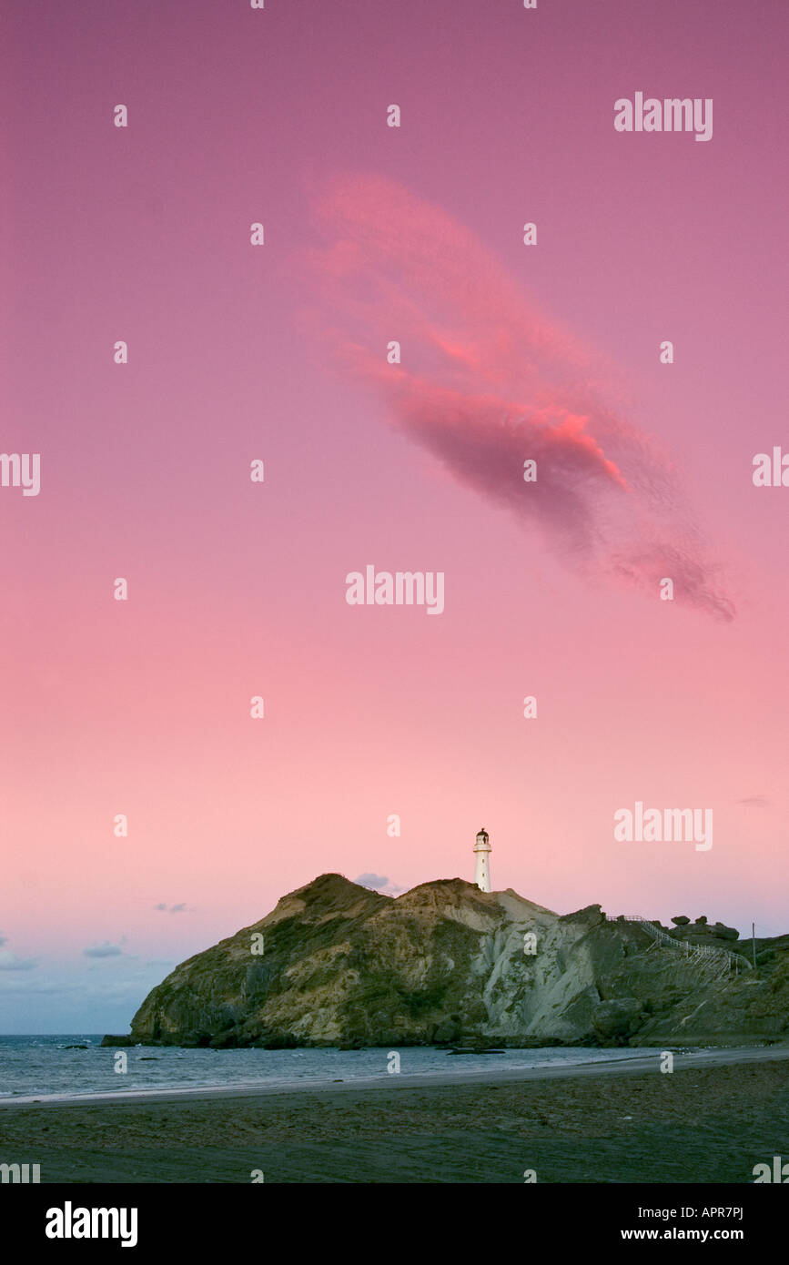 Pink sunset colours in the sky above the lighthouse at Castlepoint ...