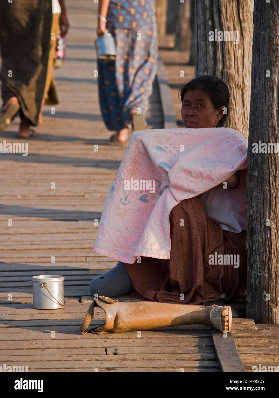disabled woman with prosthetic leg begging on the U Bein teak bridge in ...