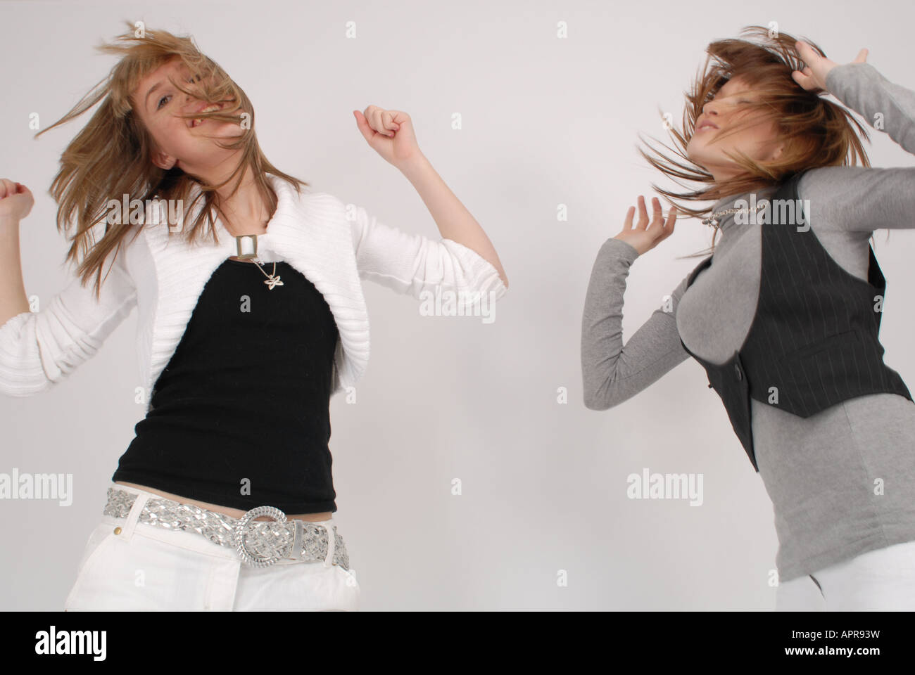 Two girls dancing shaking their heads around in a very energetic ...