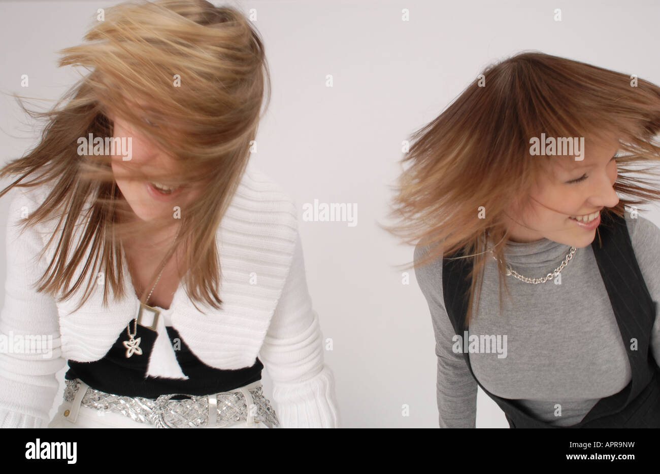 Two girls dancing shaking their heads around in a very energetic ...