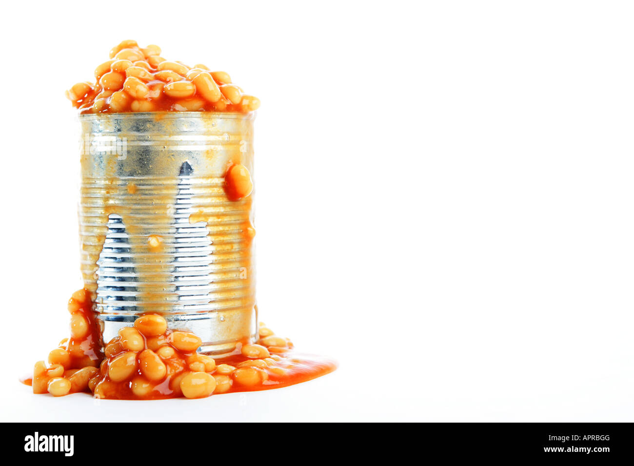A tin of baked beans over flowing against a white background Stock ...