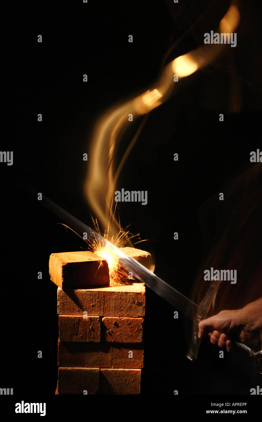 Sword cutting through brick Stock Photo - Alamy