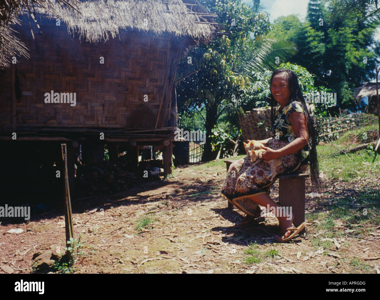Woman sitting outside rural home laos hi-res stock photography and ...