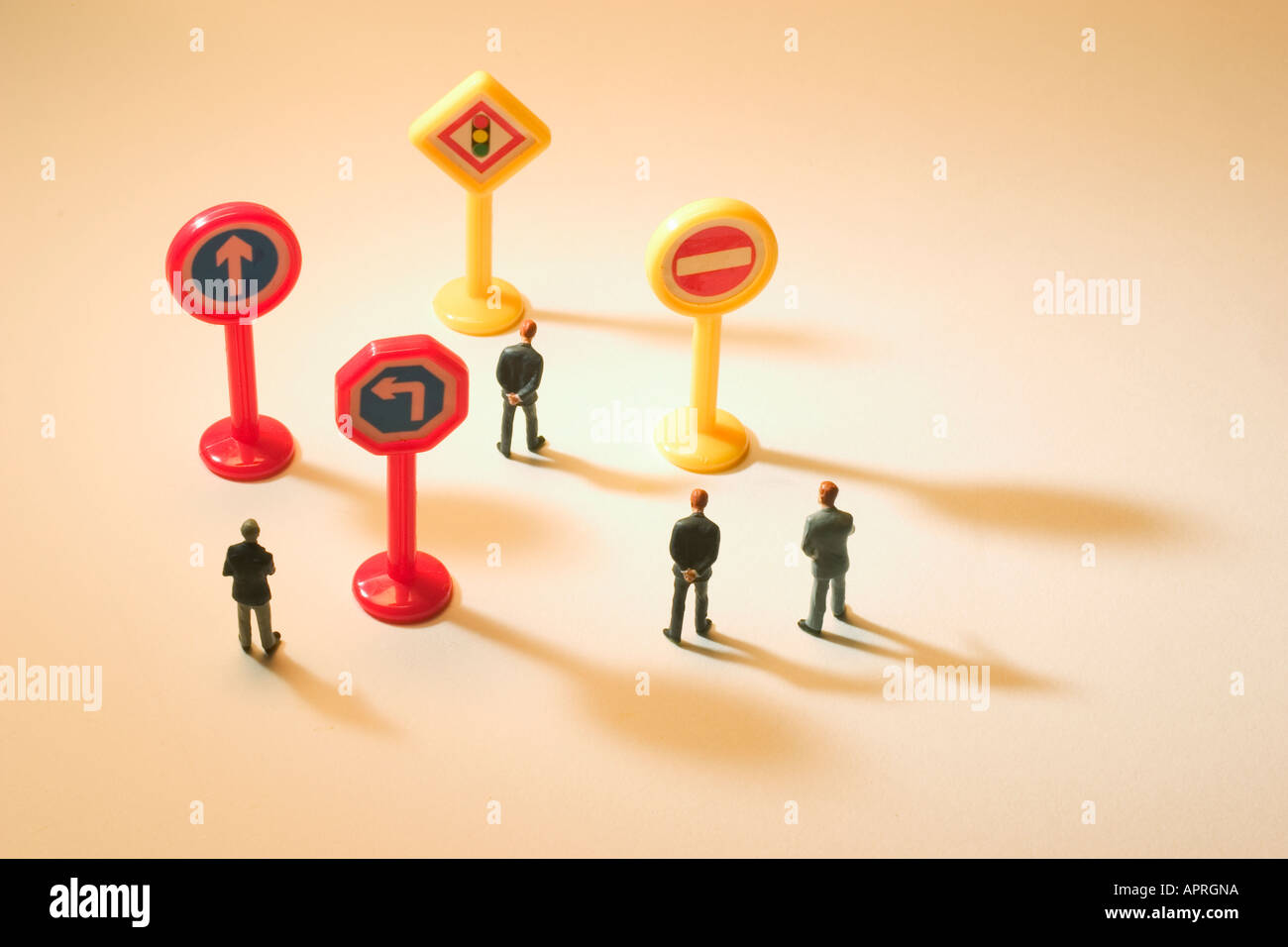 Businessman Figures with Traffic Signs Stock Photo - Alamy