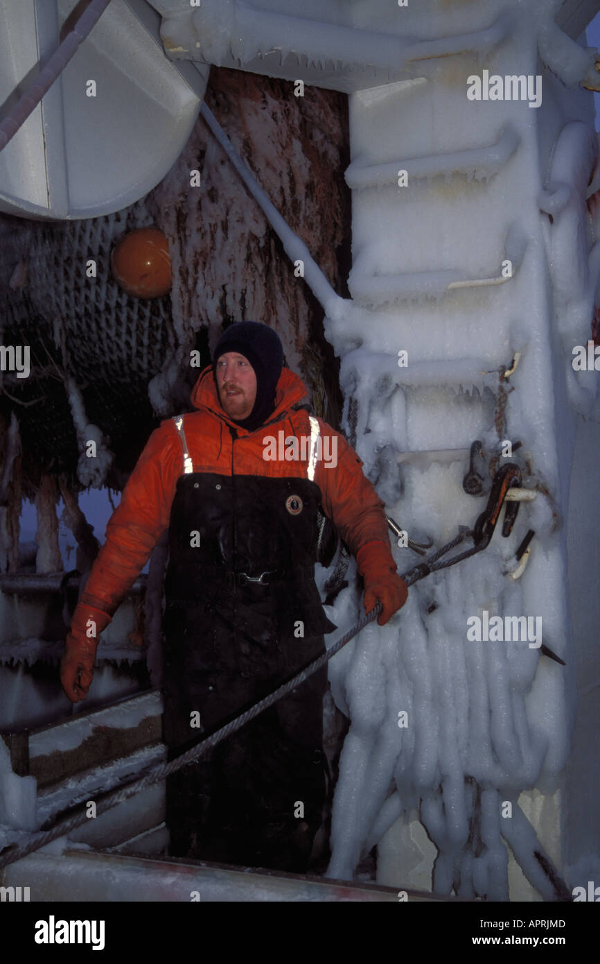 commercial fishing working next to freeze spray on the back of a boat ...