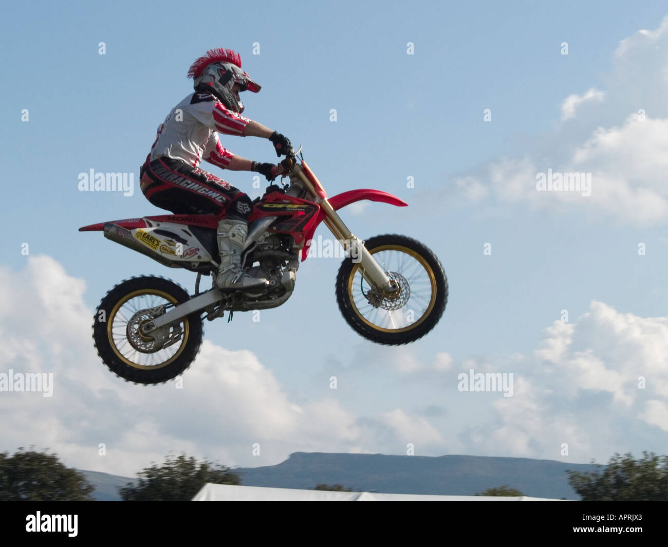 Stunt rider doing a high jump on a motor cycle at Stokesley ...