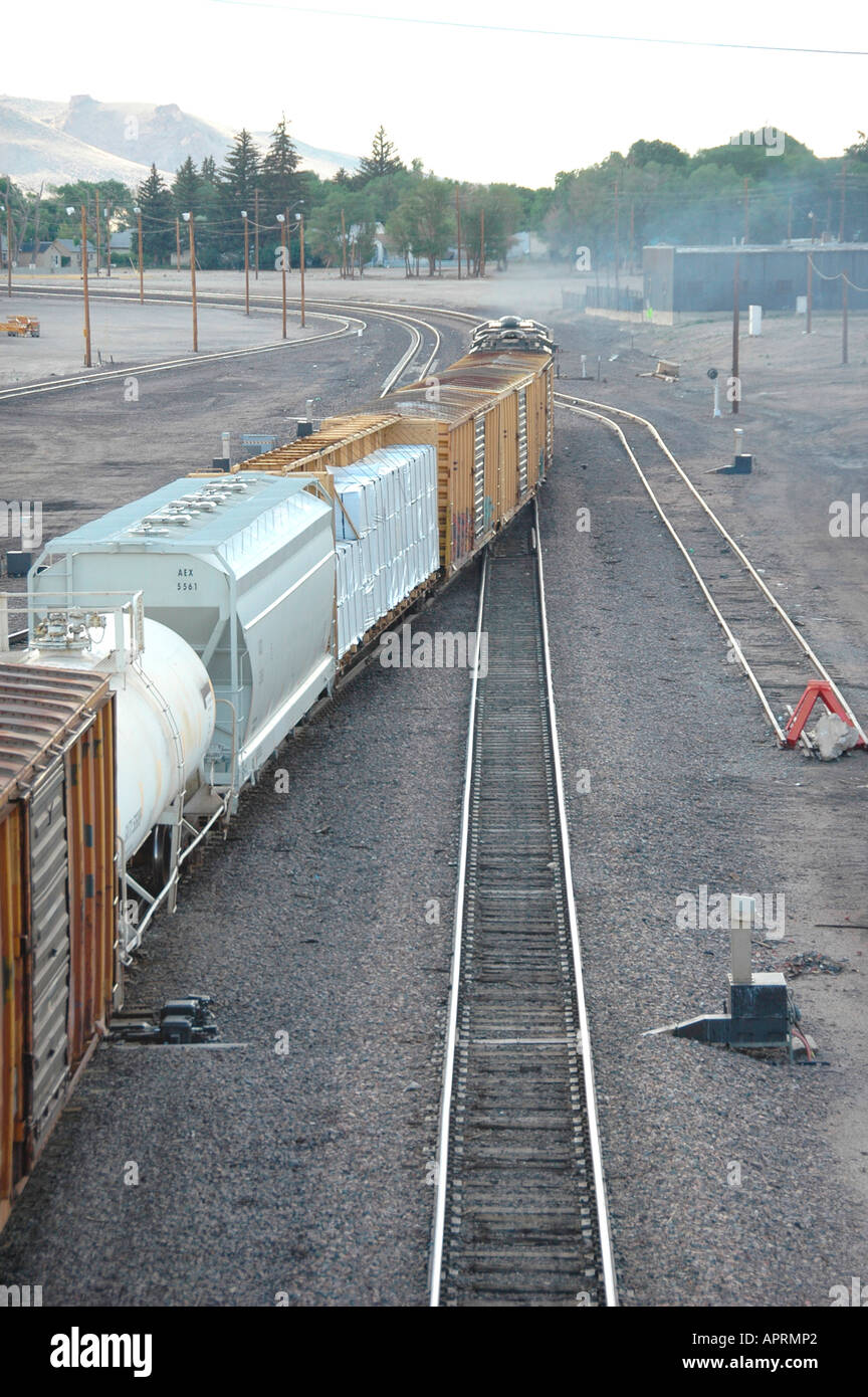 Railroad train yard with sidings and switchers and engines and cars and ...