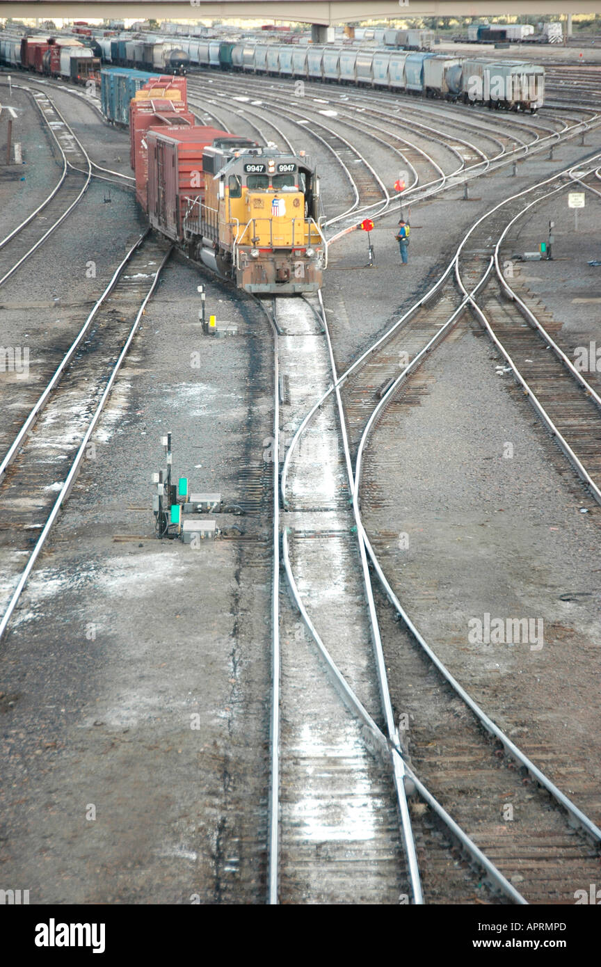 Railroad train yard with sidings and switchers and engines and cars and ...