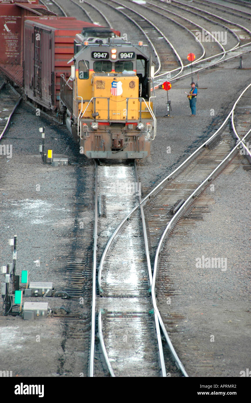 Railroad train yard with sidings and switchers and engines and cars and ...