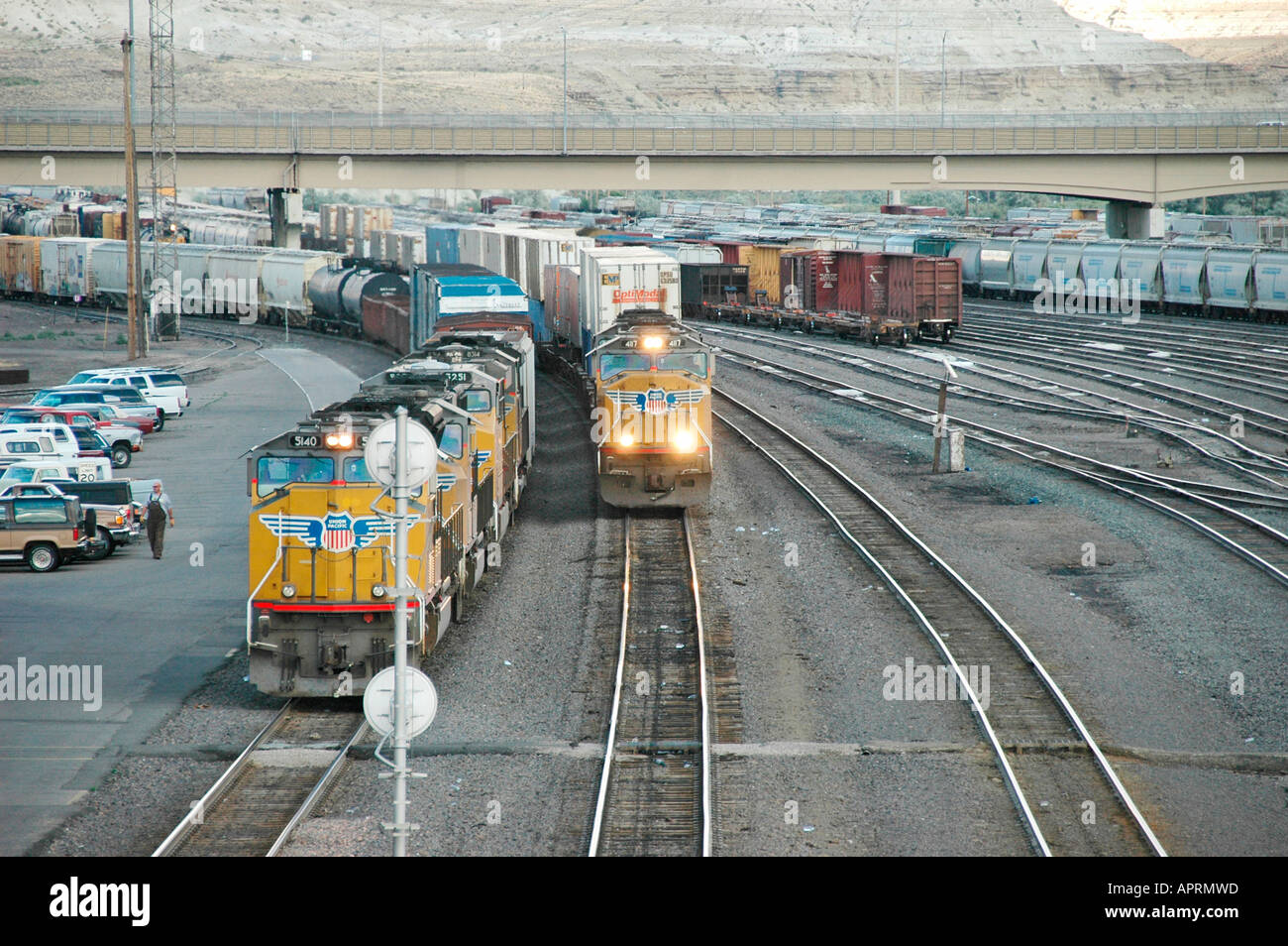 Railroad train yard with sidings and switchers and engines and cars and ...