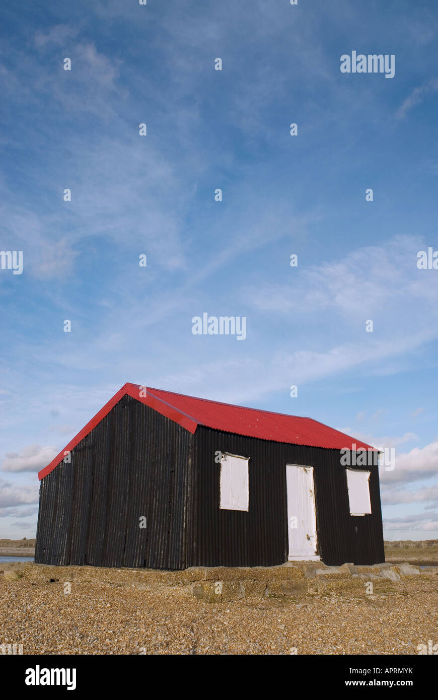 Corrigated iron red roofed shed on the beach Stock Photo - Alamy