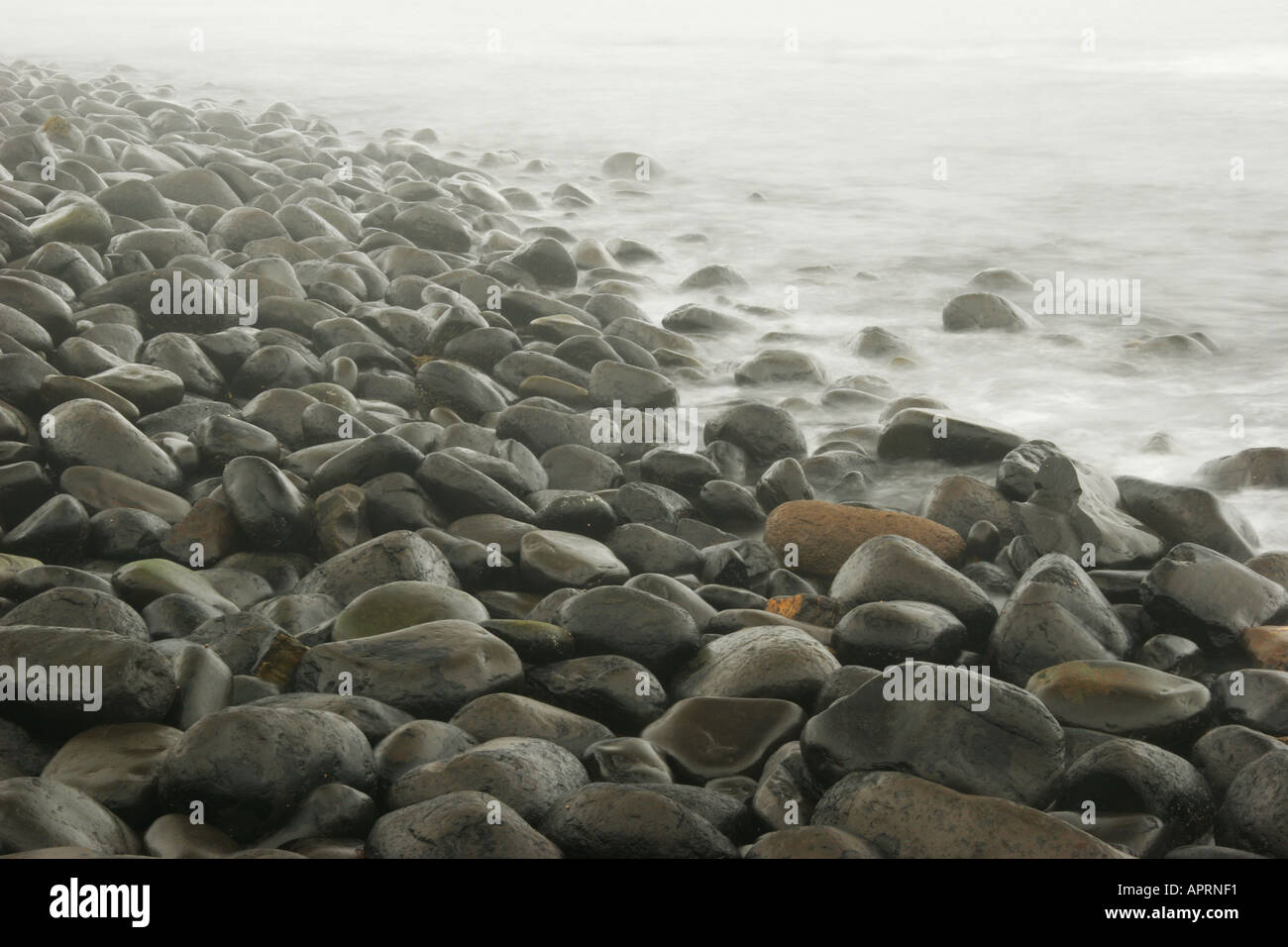 Sea Water and rocks at Dunstanburgh Beach in Northumberland England UK ...