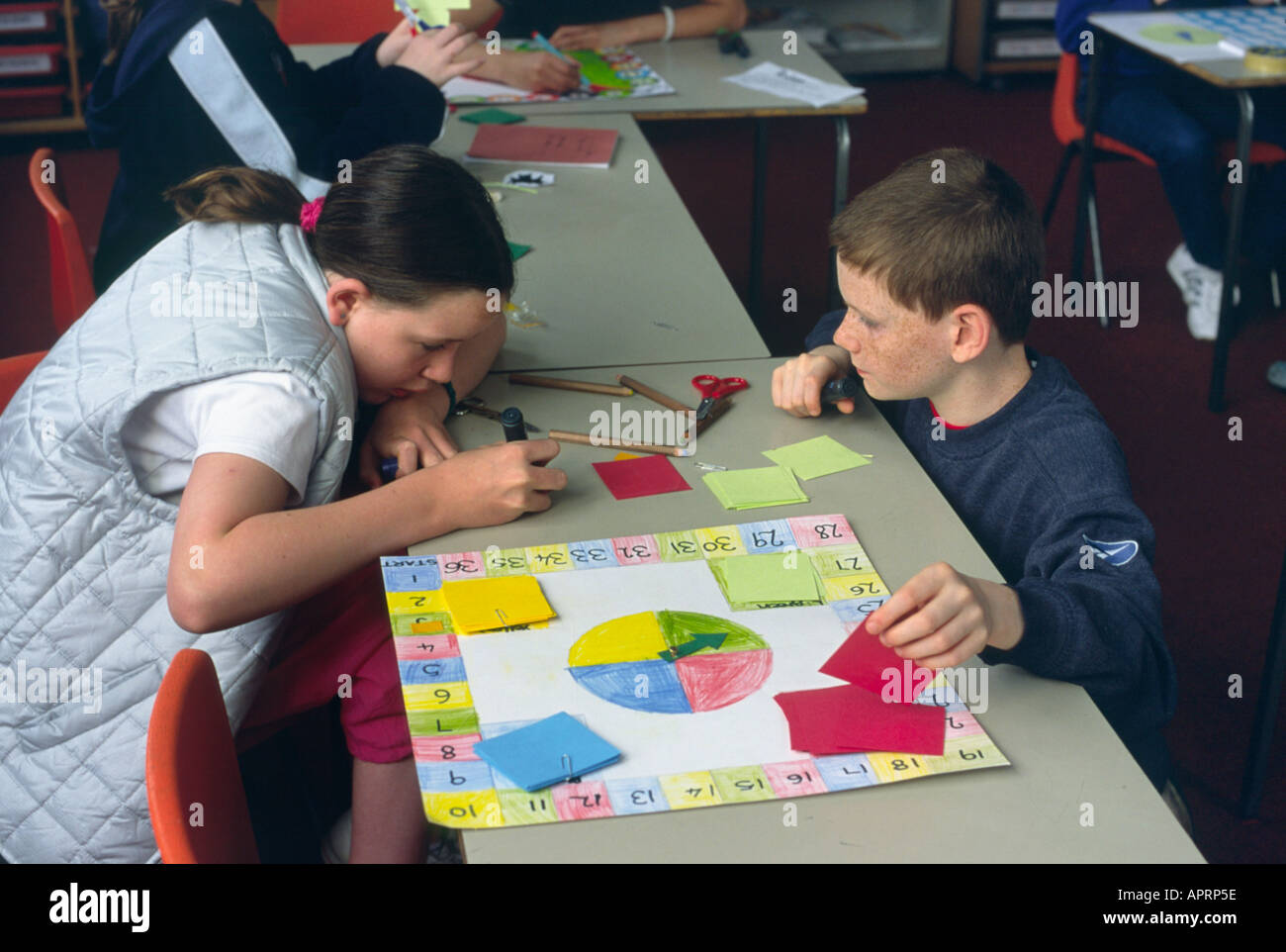 primary school children playing with a number game in a math lesson ...