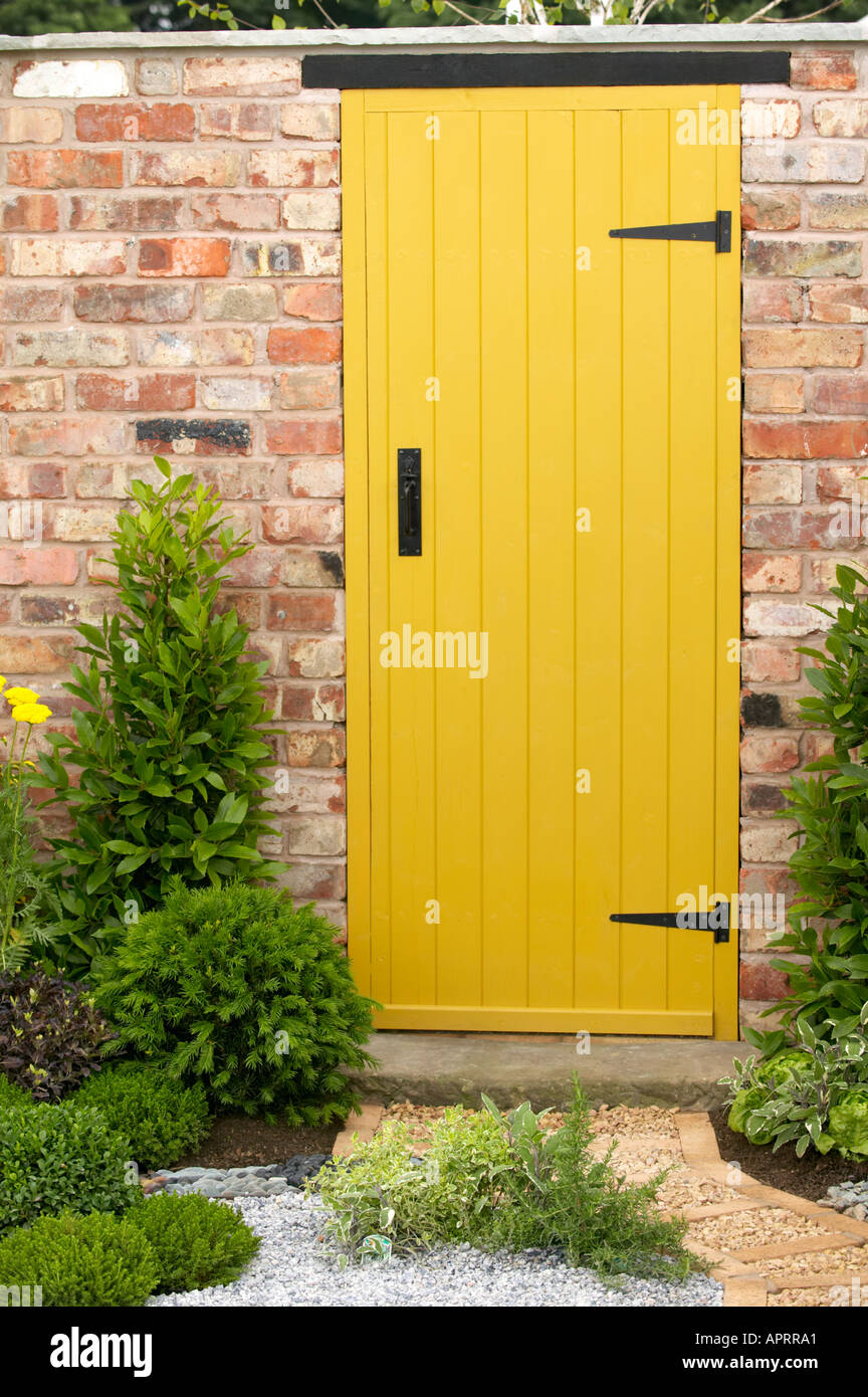 Yellow back yard gate with shrubsTatton Flower Show Stock Photo - Alamy