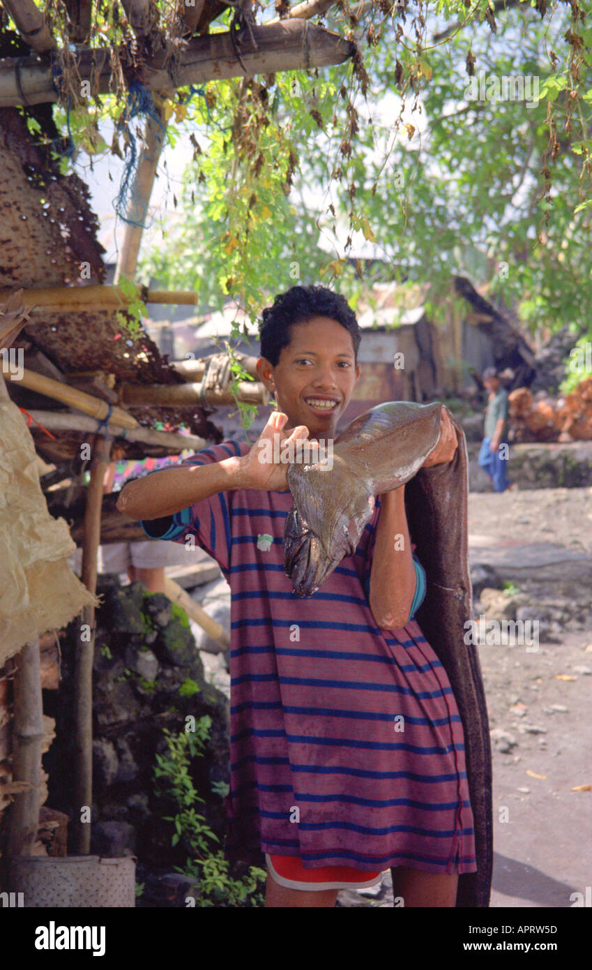 Boy carrying a large fish, Banda island, Indonesia Stock Photo - Alamy