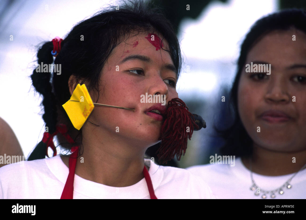 A female spirit medium with pierced cheek during Vegetarian festival in ...