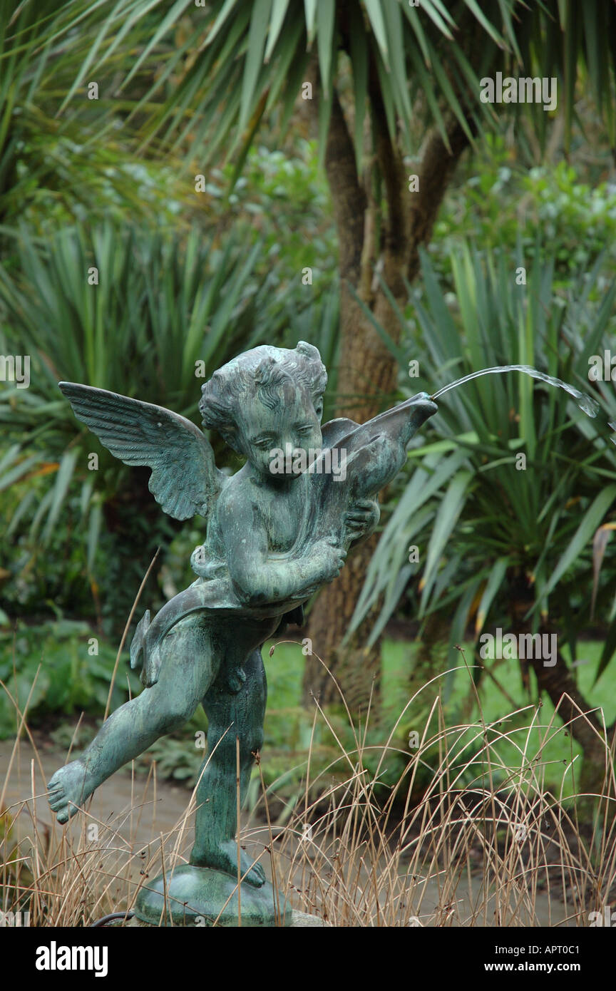 Baby angel dolphin statue fountain in Lost gardens of Heligan Cornwall ...
