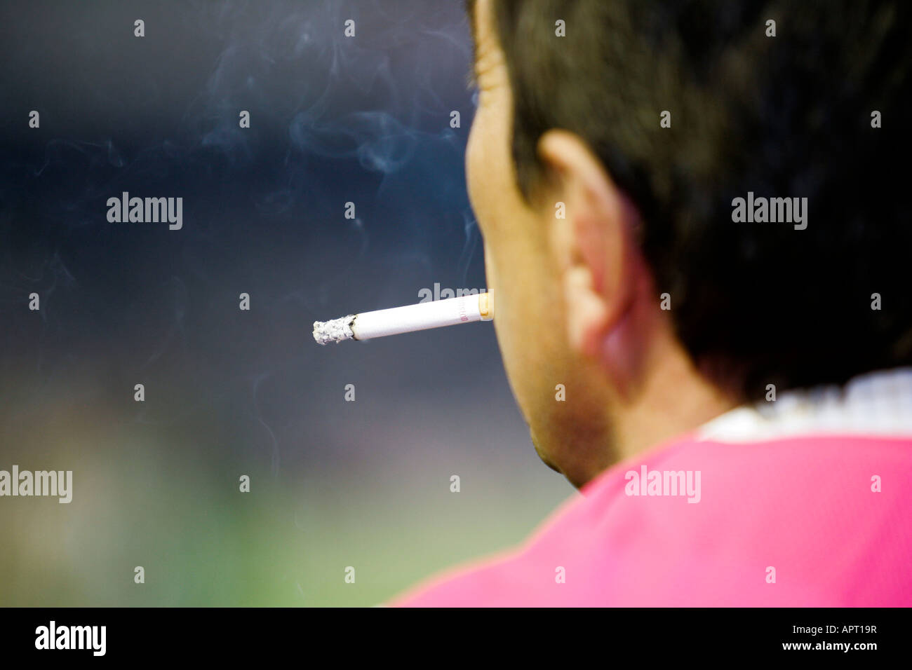 Rear view of a man smoking a cigarette Stock Photo - Alamy