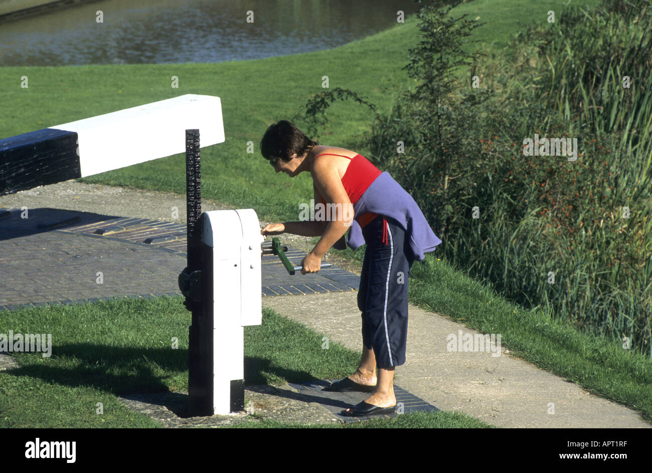 Woman opening lock paddle gate hi-res stock photography and images - Alamy